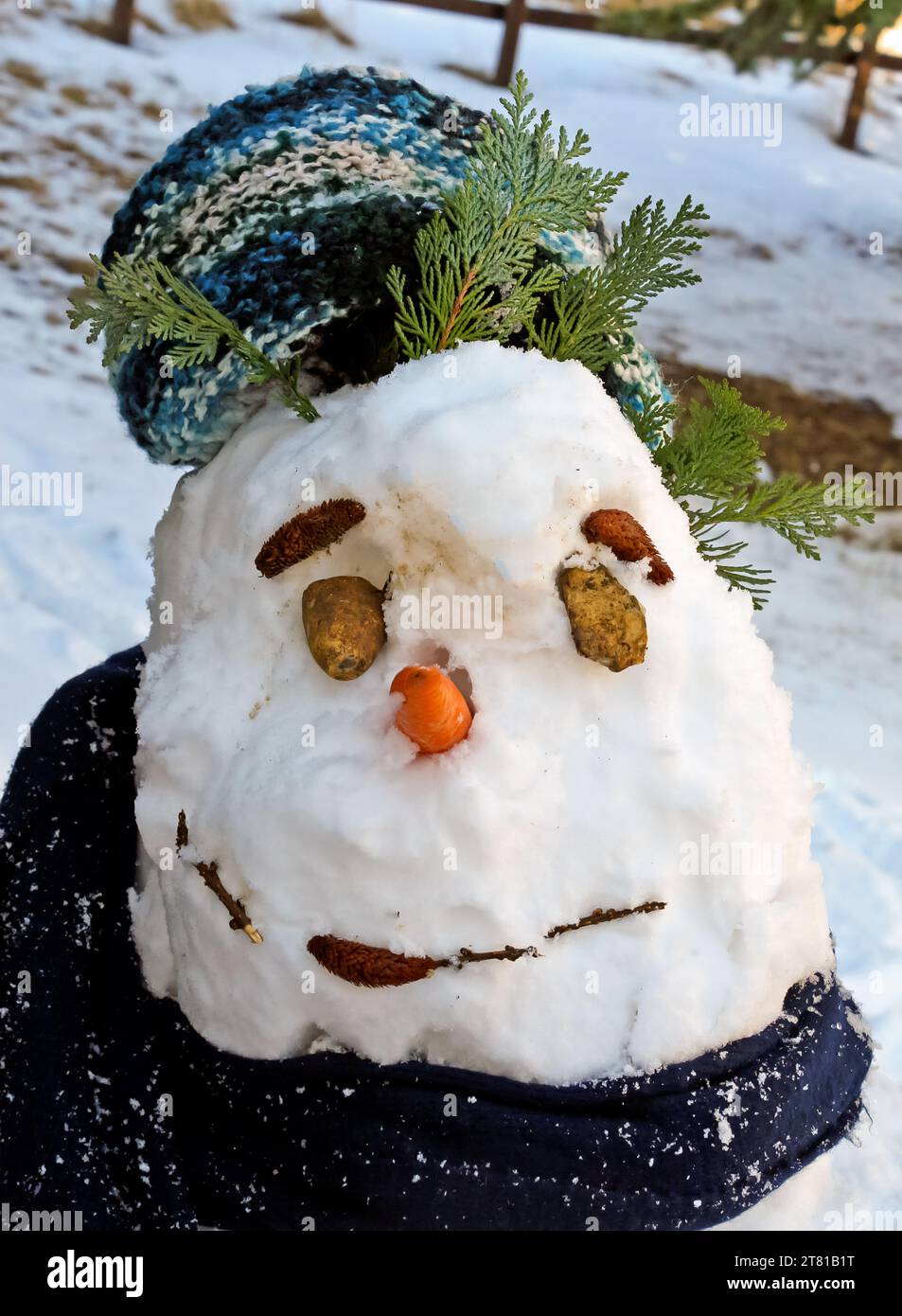 frozen smiling snowman made by children after snowfall in the mountains ...
