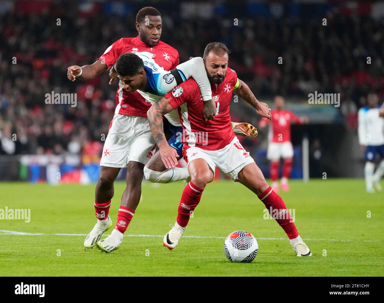 England's Marcus Rashford, centre, challenges for the ball with Malta's ...