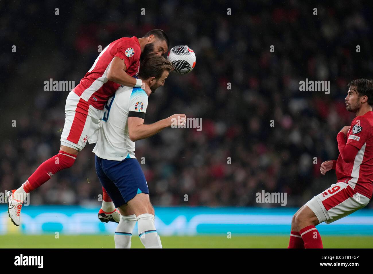 Malta's Enrico Pepe, left, challenges for the ball with England's Harry ...