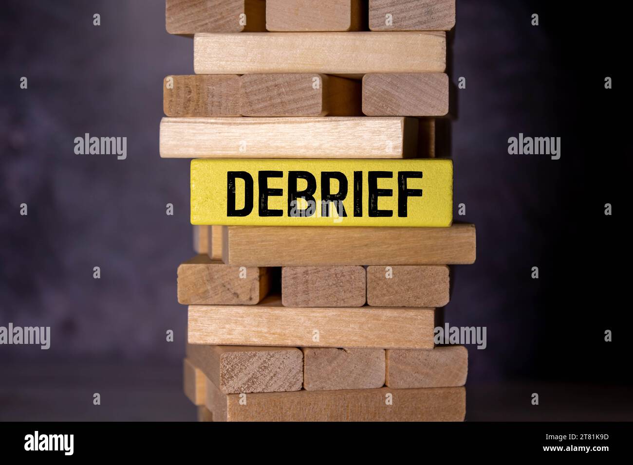 Debrief symbol. Concept word Debrief on wooden blocks. Beautiful grey ...