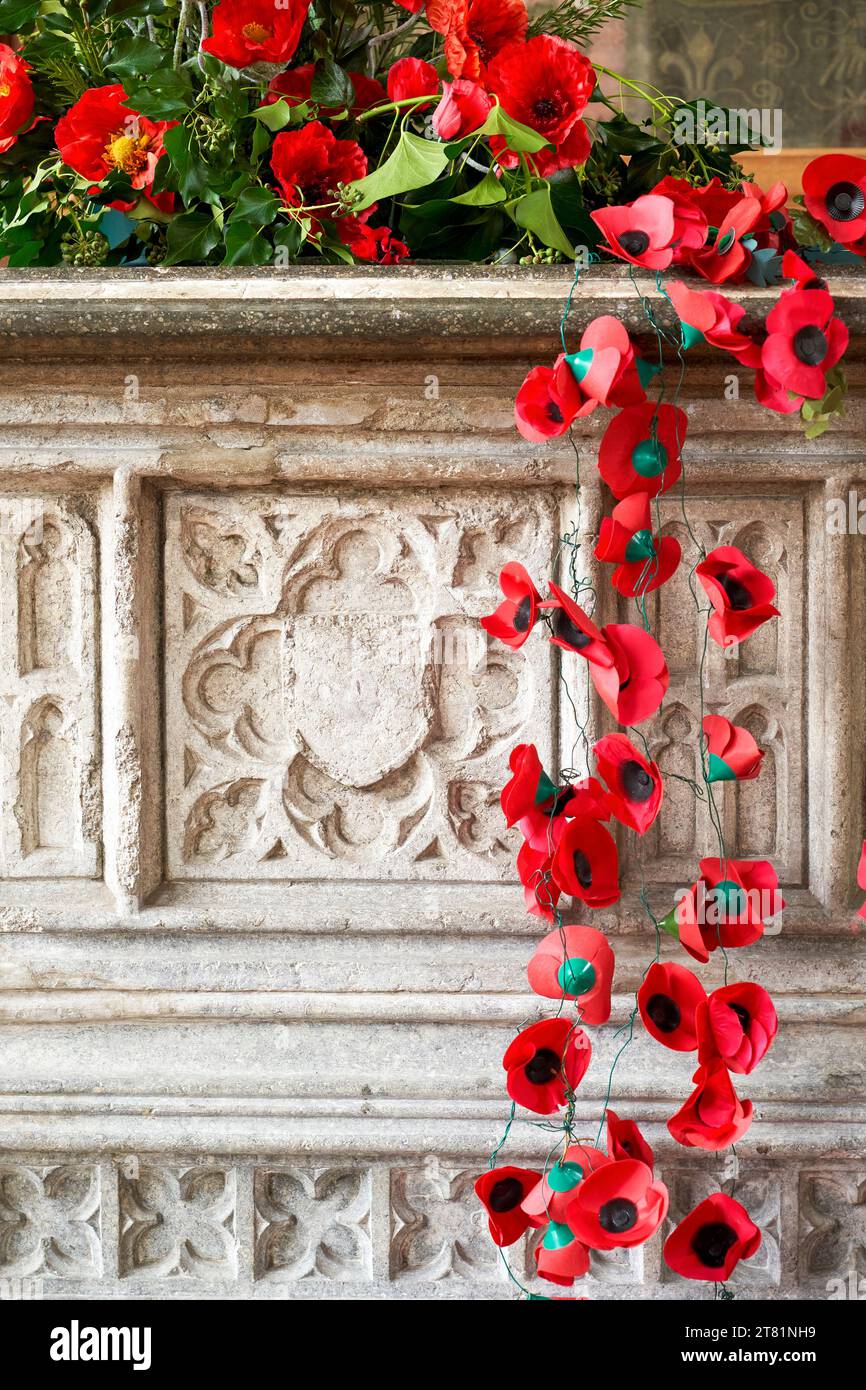 Red poppy display over an old carved stone tomb Stock Photo - Alamy