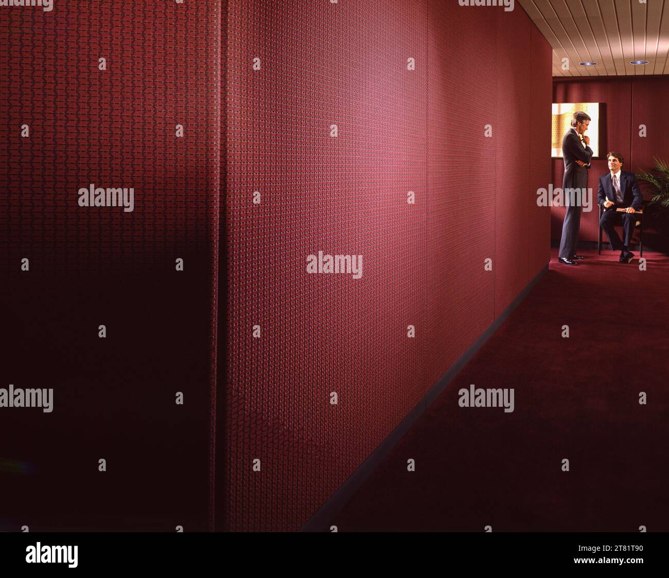 Businessmen in hallway conversation. Copy space Stock Photo - Alamy