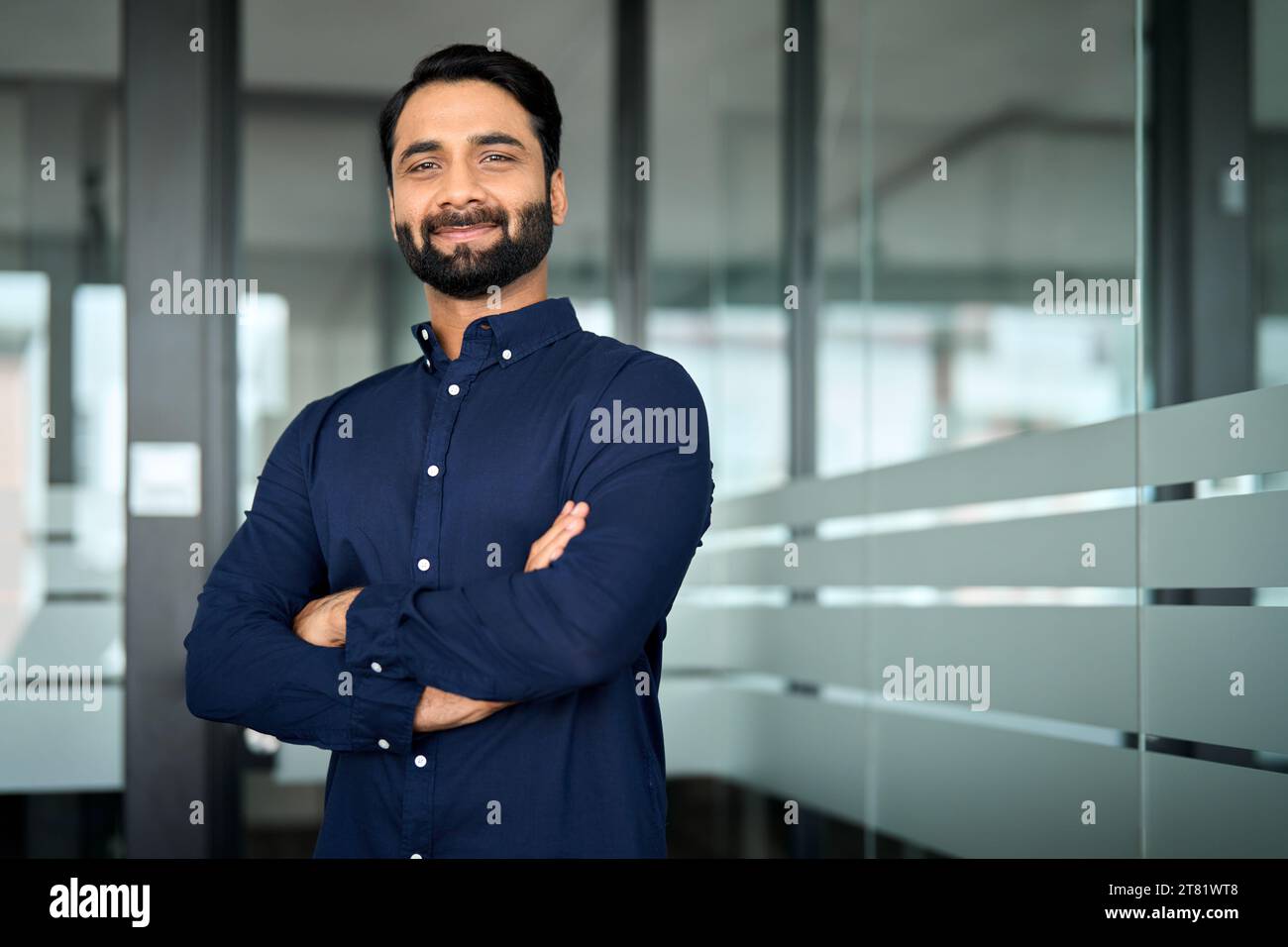 Happy confident Indian businessman standing arms crossed in office ...