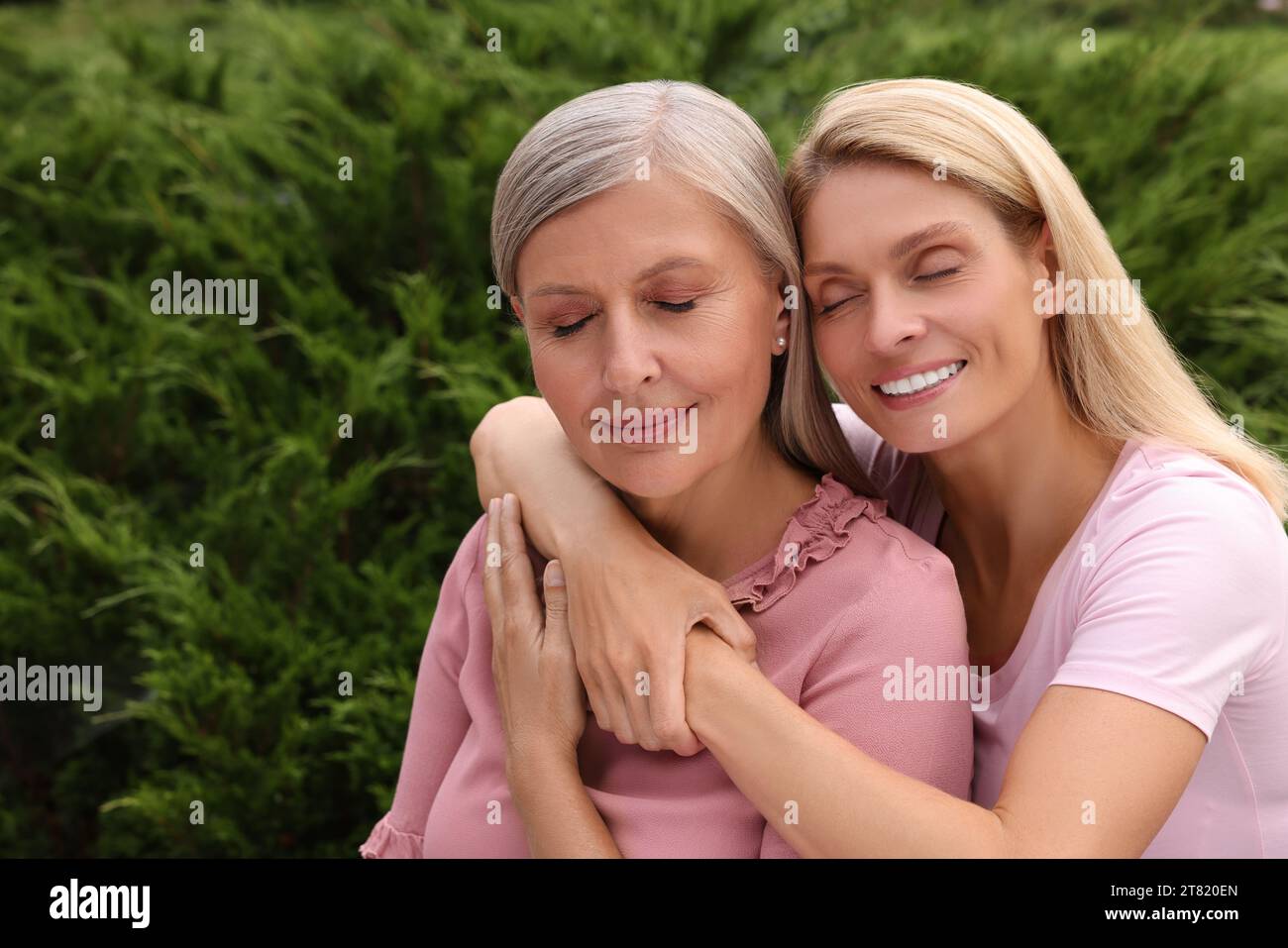 Happy mature mother and her daughter hugging outdoors Stock Photo - Alamy