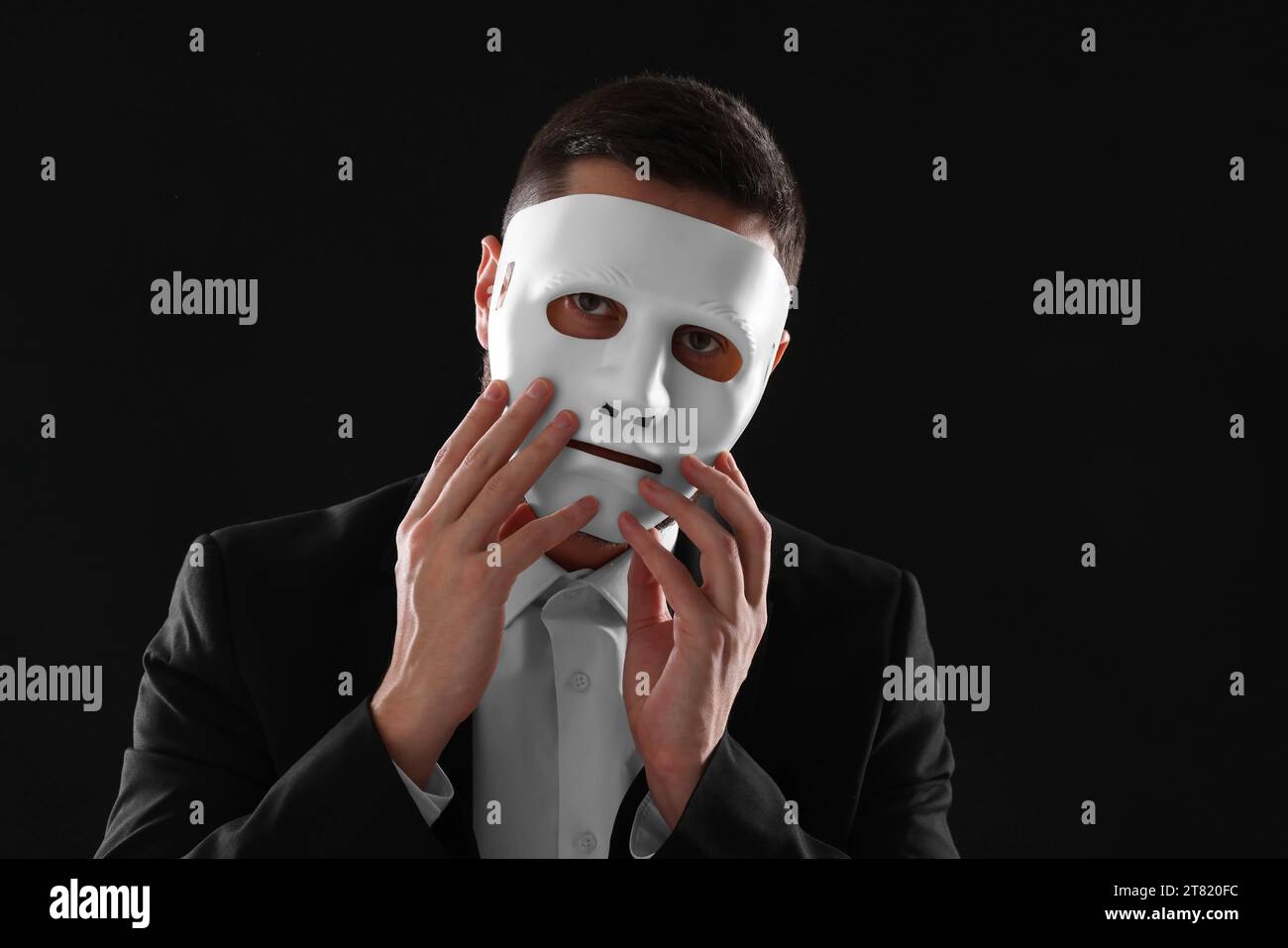Multiple personality concept. Man in mask on black background Stock ...