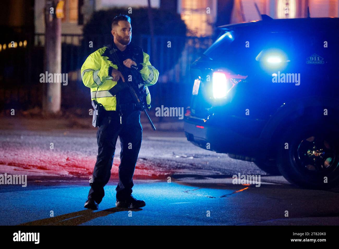 A police officer mans a road block on a street leading to New Hampshire ...