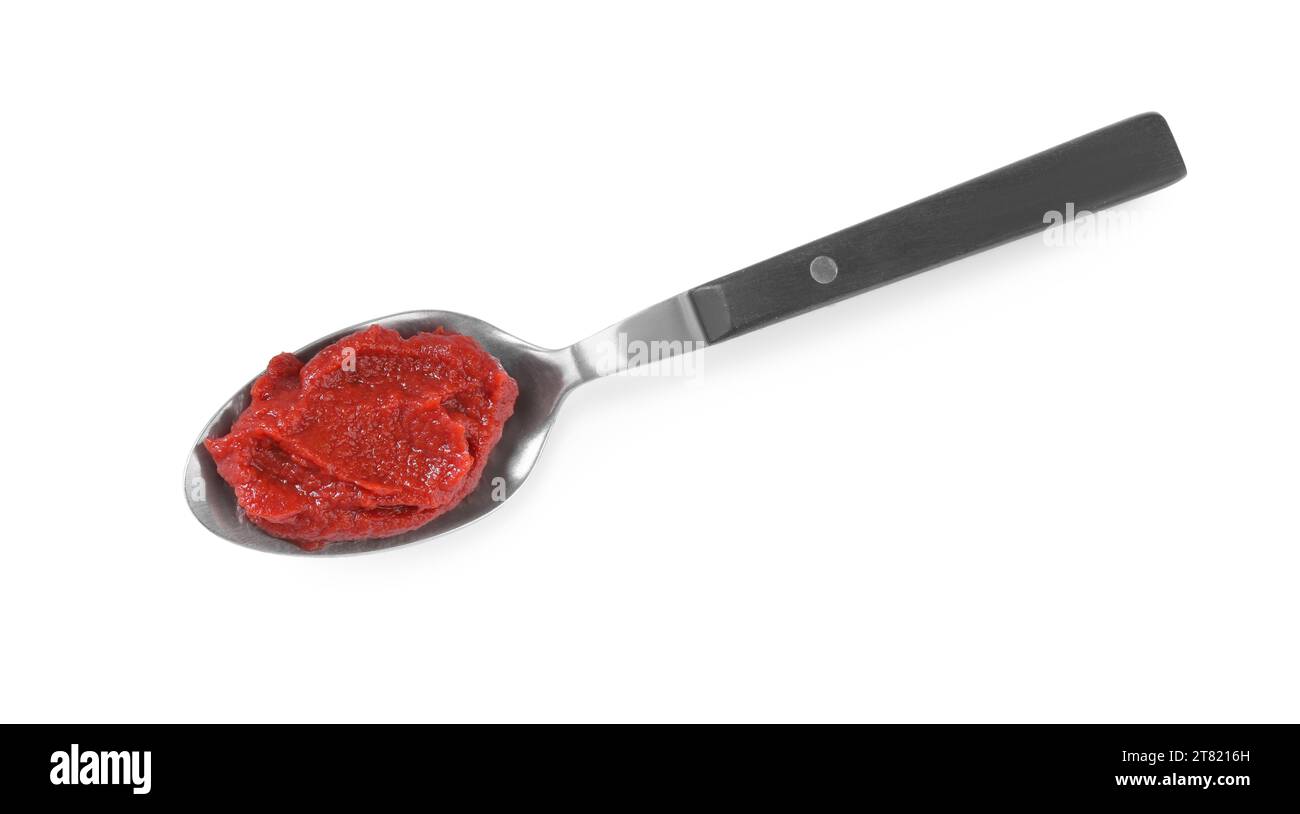 Spoon of tasty tomato paste isolated on white, top view Stock Photo - Alamy