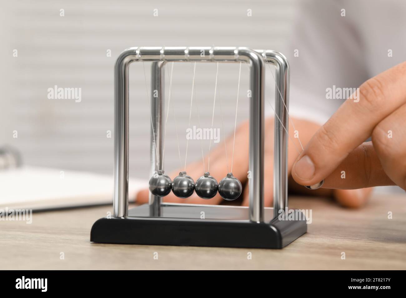 Newton's cradle and hand hi-res stock photography and images - Alamy