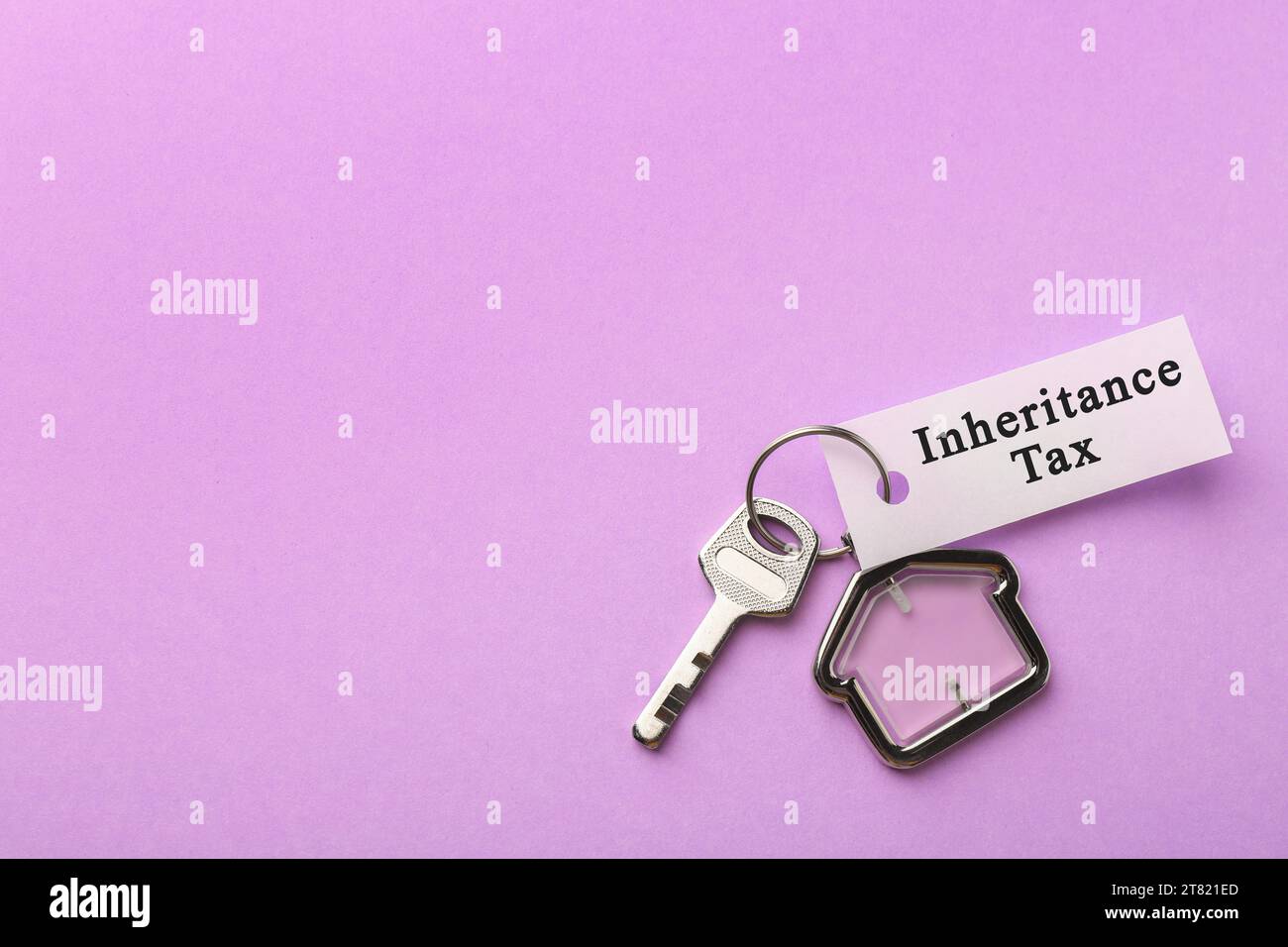 Card with phrase Inheritance Tax attached to key with house shaped key ... Card with phrase Inheritance Tax attached to key with house shaped key ...