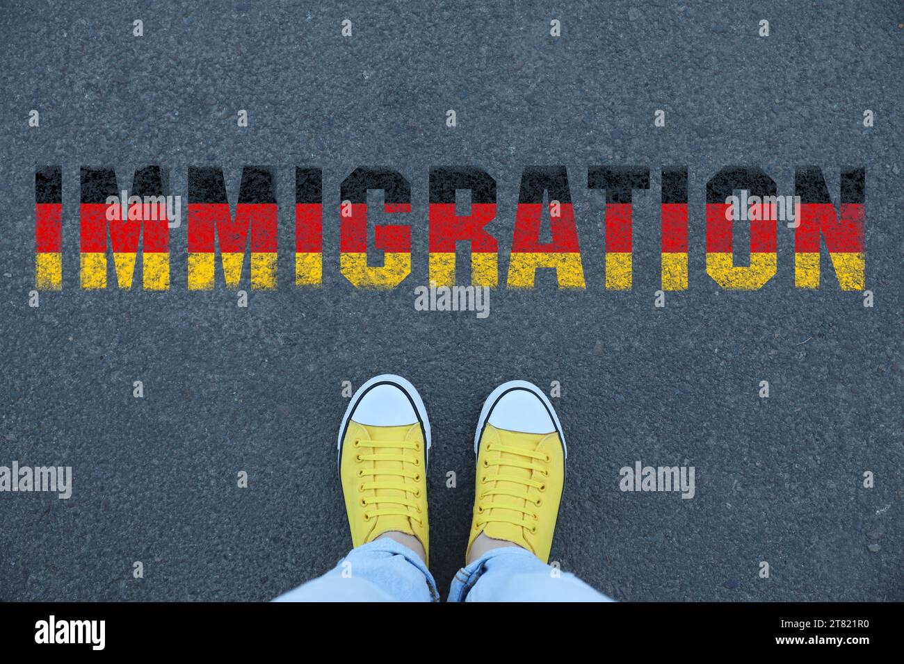 Woman standing on asphalt near word Immigration in colors of flag of ...