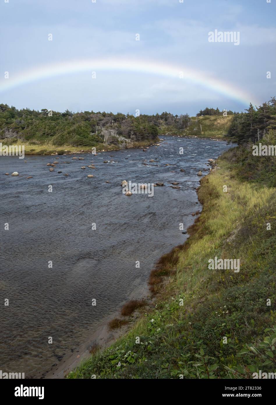 Rainbow over green banks of outlet for Western Brook Pond into the Gulf ...