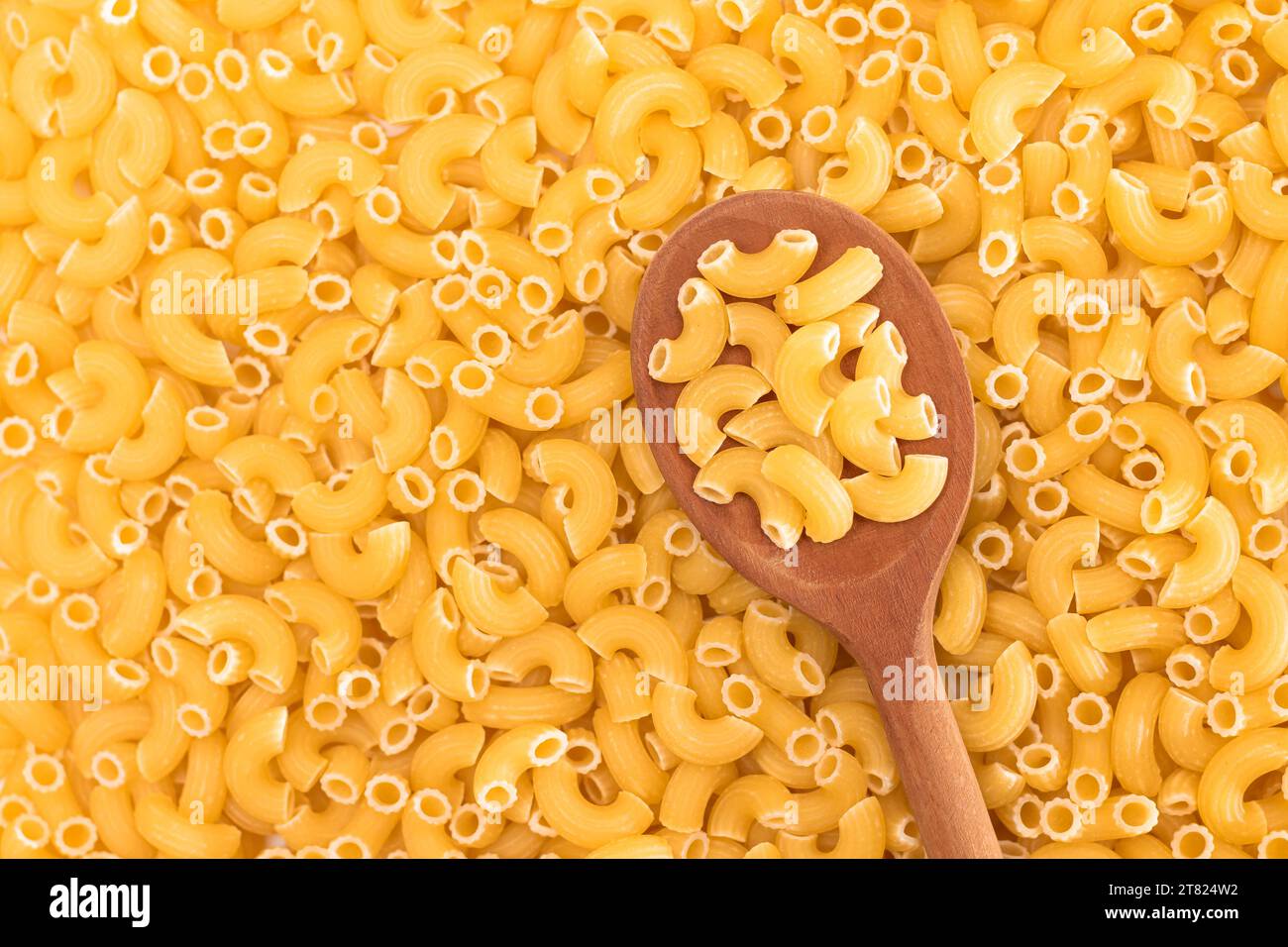 Uncooked Chifferi Rigati Pasta Background with Wooden Spoon. Fat and ...