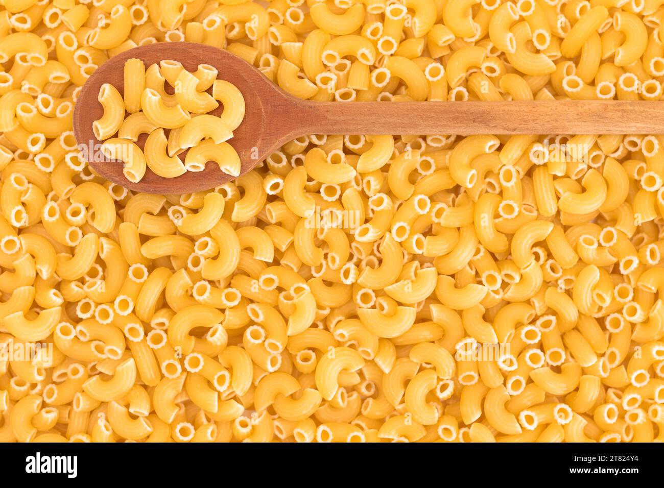 Uncooked Chifferi Rigati Pasta Background with Wooden Spoon. Fat and ...