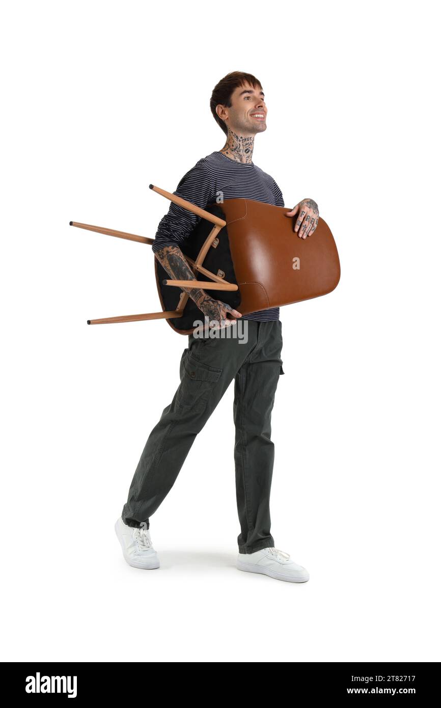 Young man carrying chair on white background Stock Photo - Alamy