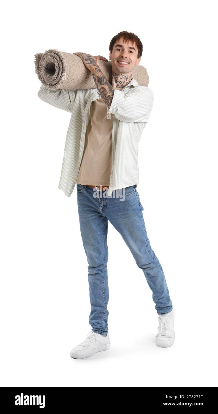 Young man carrying rolled carpet on white background Stock Photo - Alamy