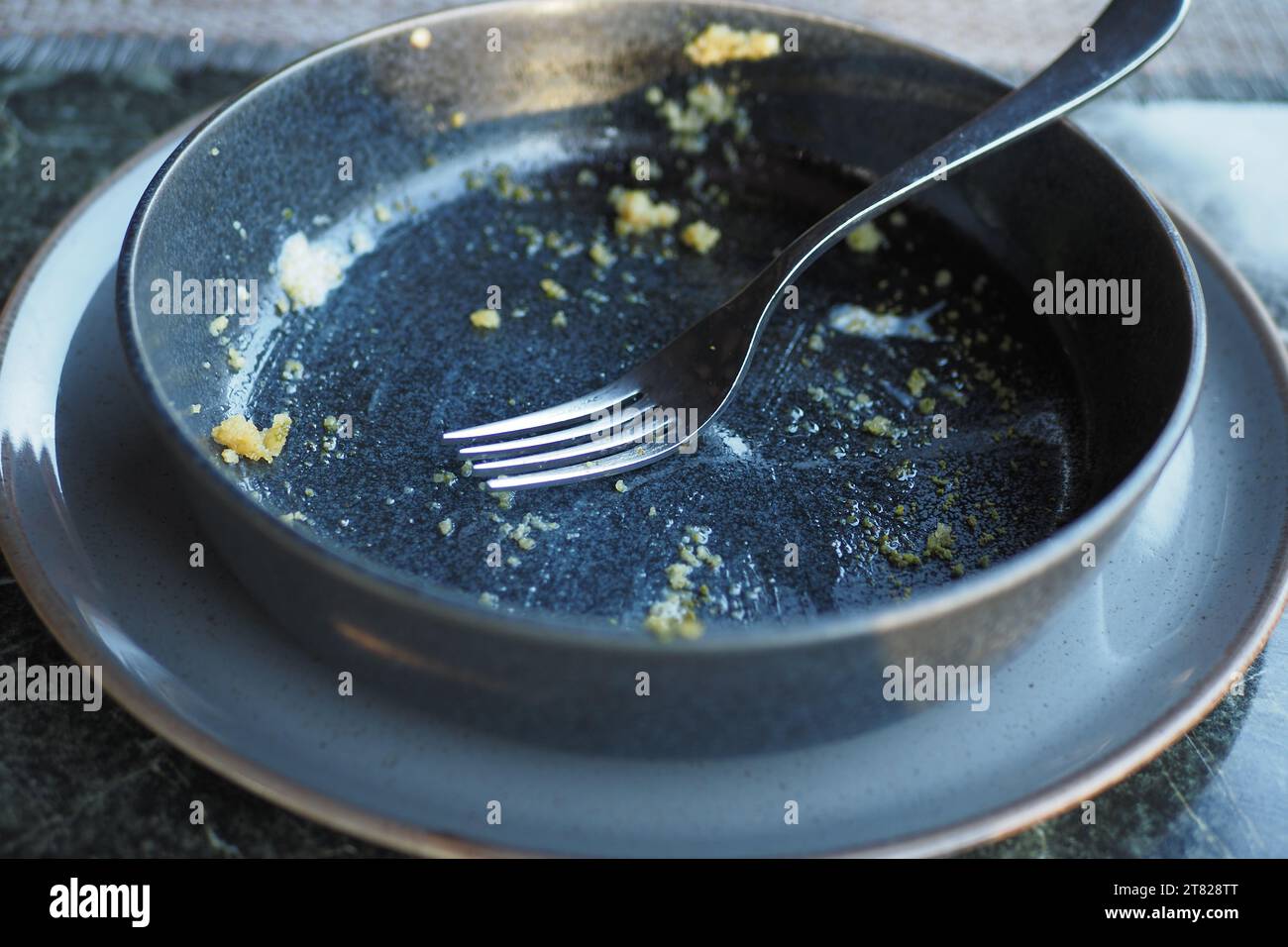 Empty plate after eating on table Stock Photo - Alamy