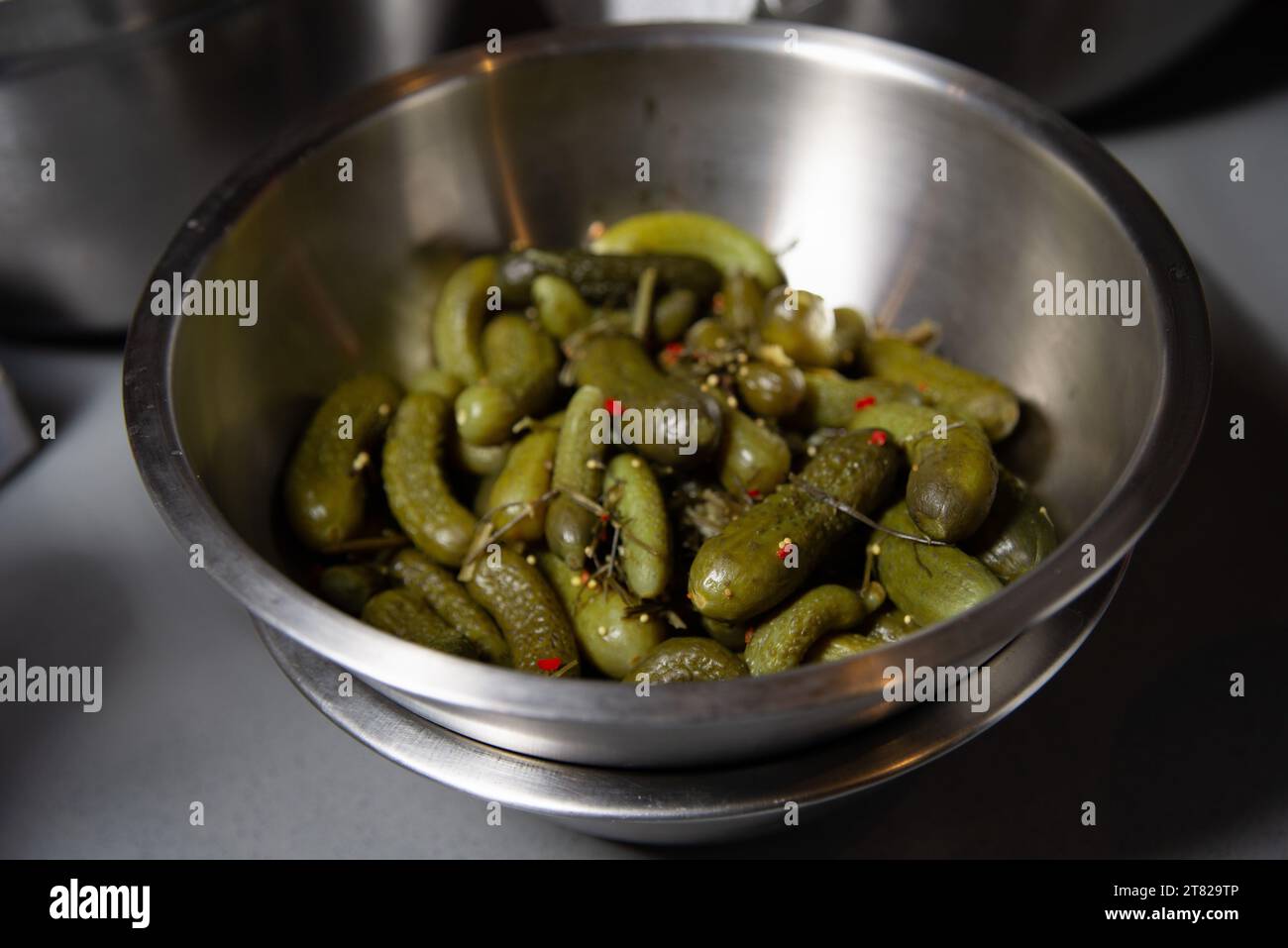Metal bowl filled with tasty fermented pickles. Perfect for salads or ...