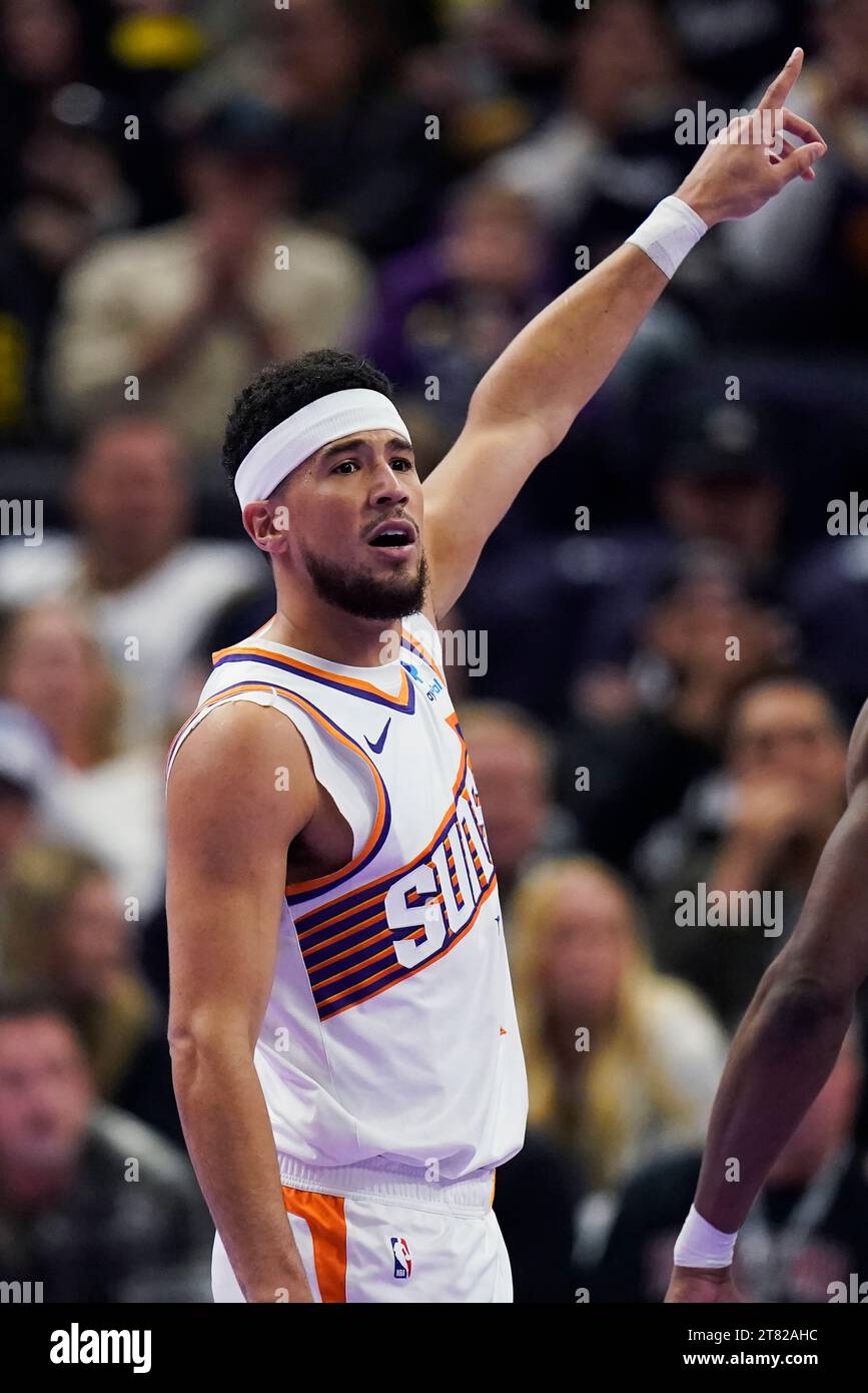 Phoenix Suns guard Devin Booker motions to teammates during the first ...