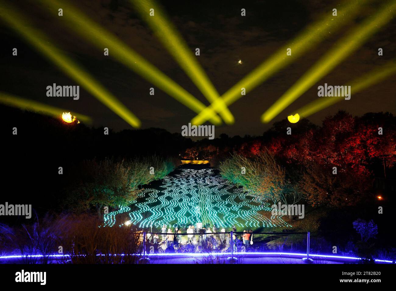 People tour the holiday light installations at Lightscape, an after ...