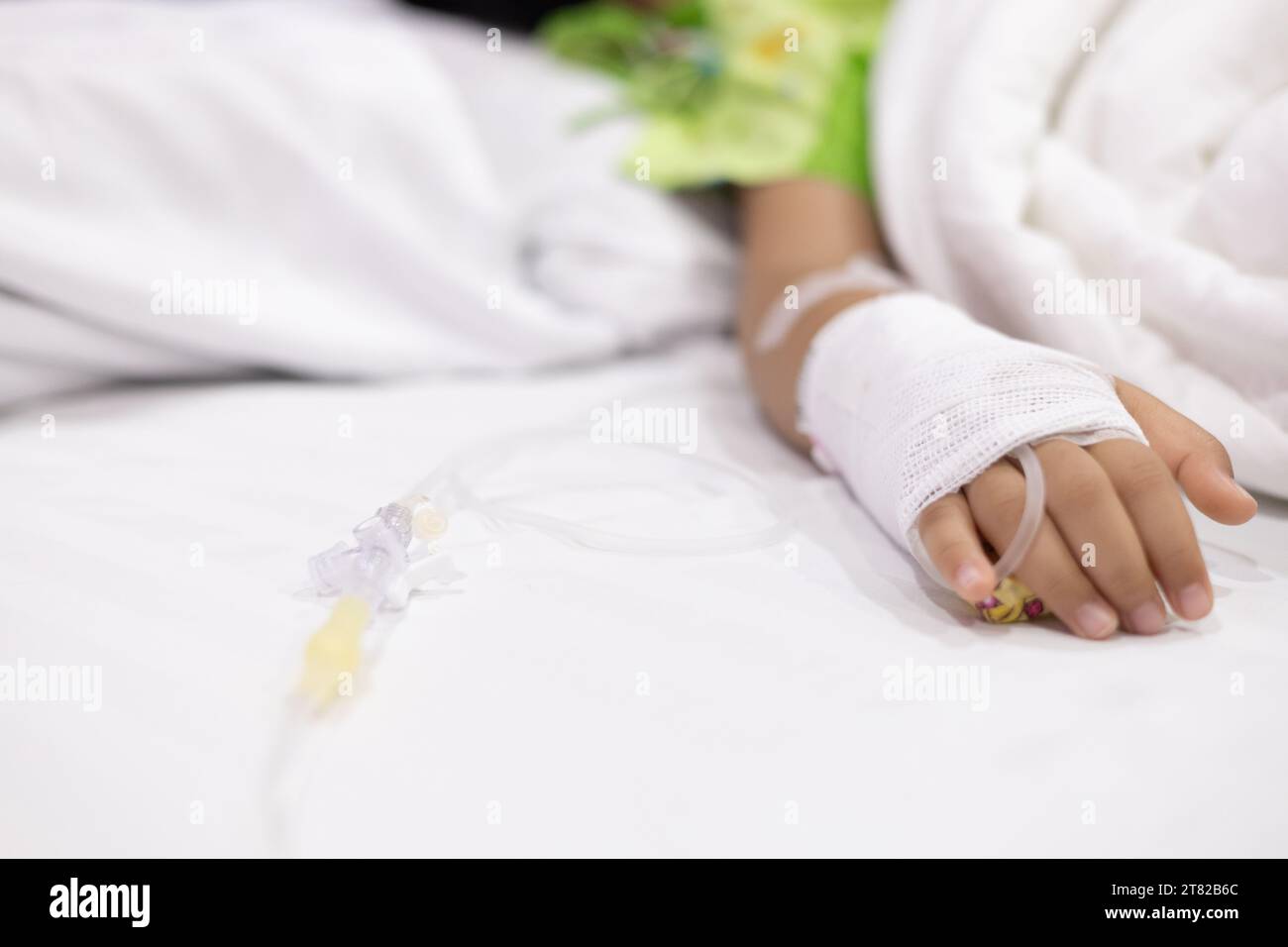 Child's hand fever patients have IV tube in hospital. Toddler girl ...