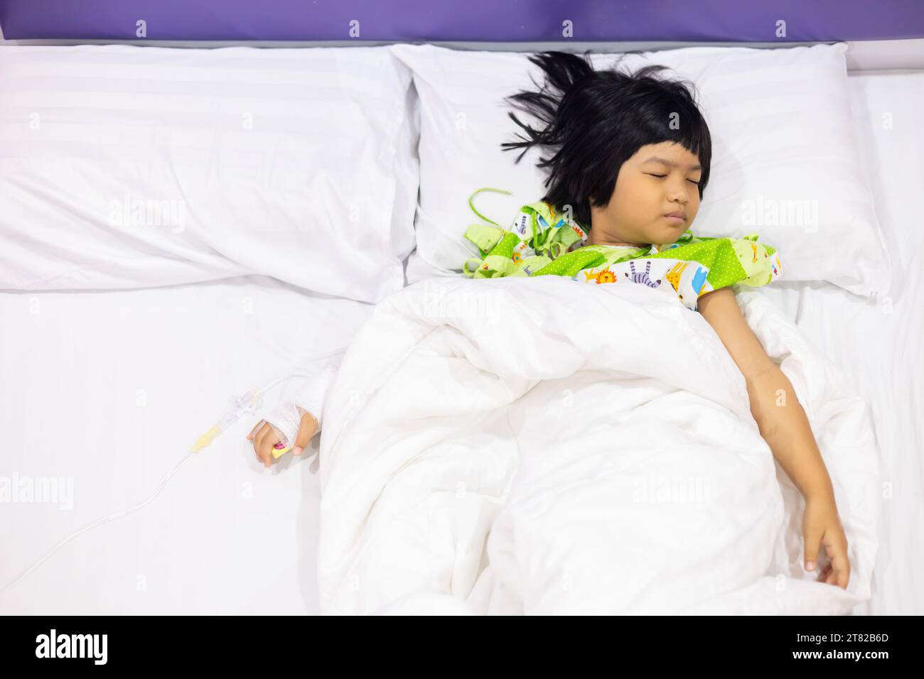 Child's hand fever patients have IV tube in hospital. Toddler girl ...