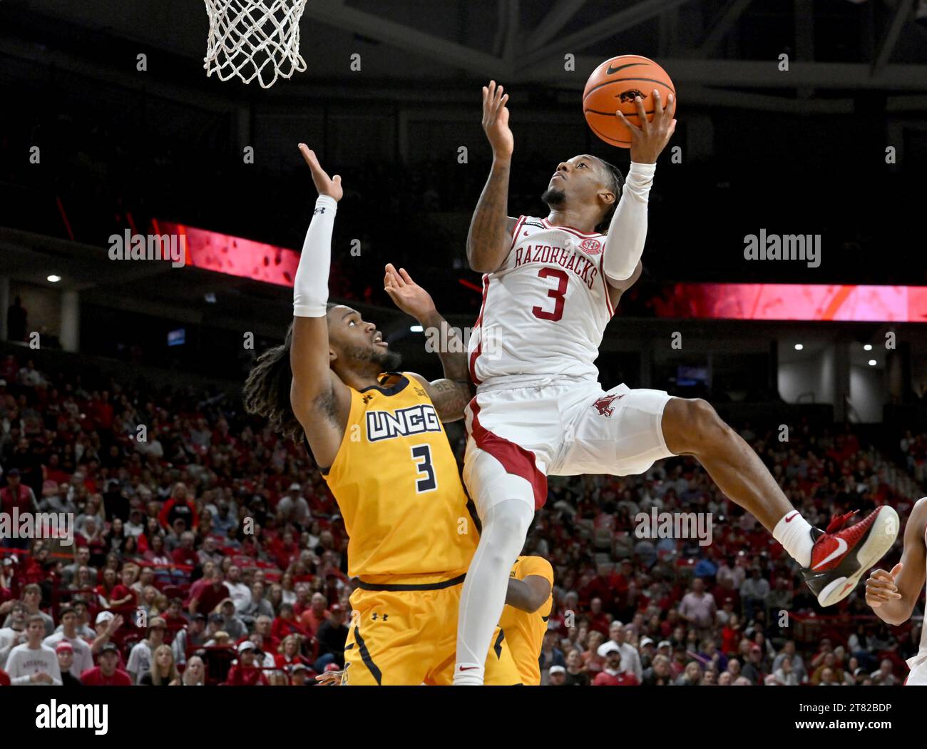 Arkansas guard El Ellis, right, tries to drive past UNC Greensboro ...