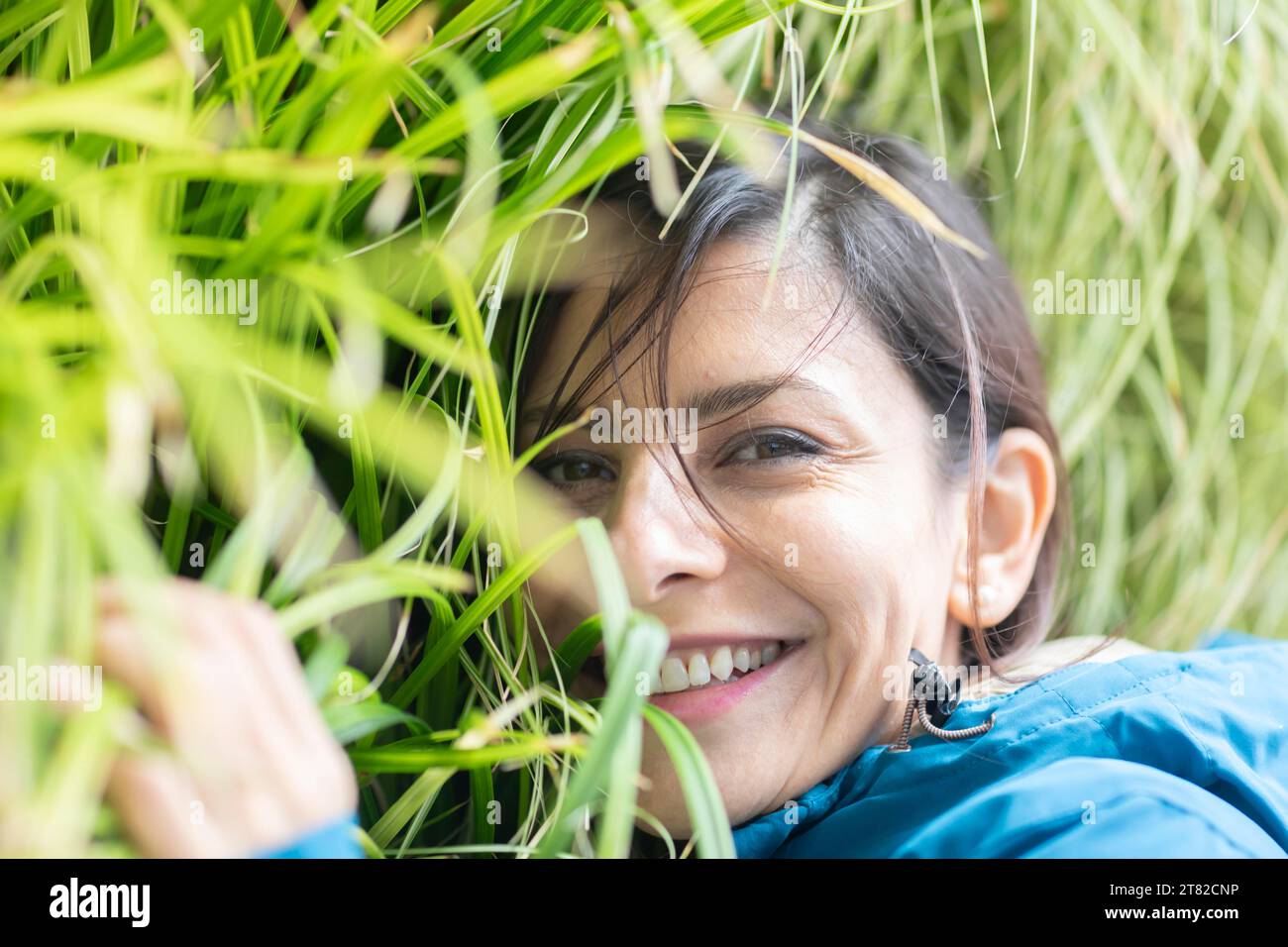 Woman cuddling in a wall of plants Environmental protection Stock Photo ...