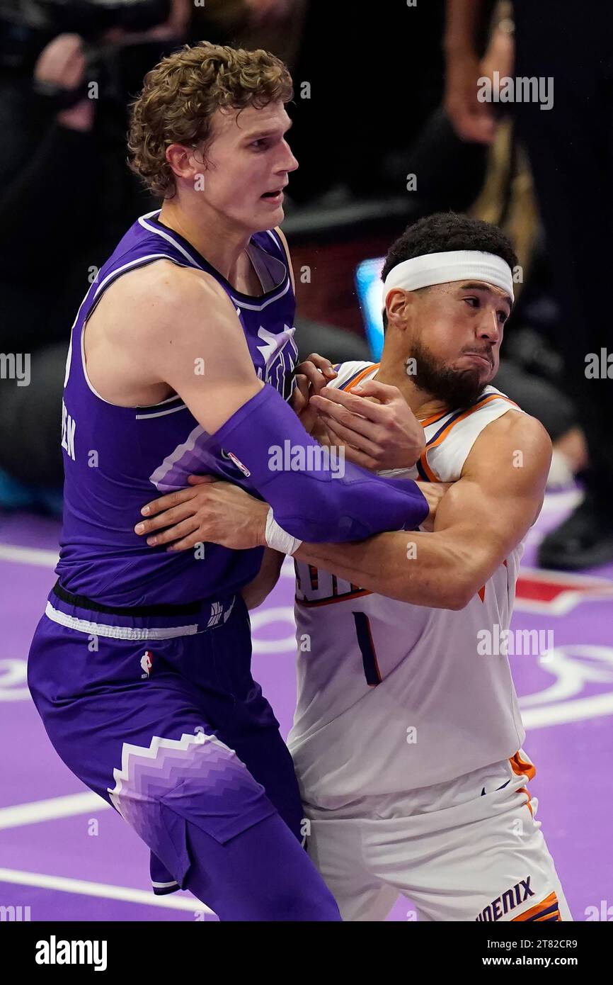 Utah Jazz forward Lauri Markkanen, left, and Phoenix Suns guard Devin Booker work for position ...