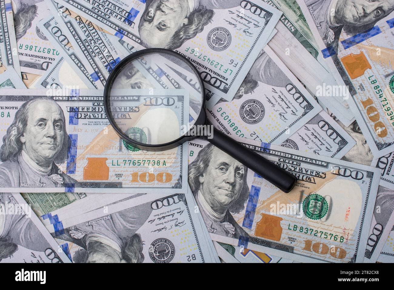 Magnifying glass is placed over of US dollar the banknotes Stock Photo ...