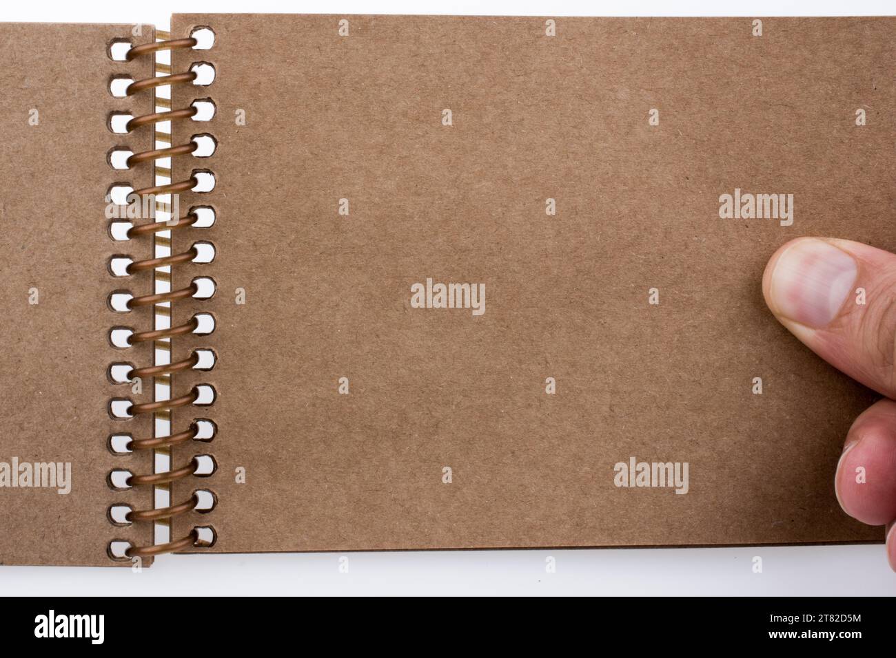 Hand holding a spiral notebook Stock Photo - Alamy