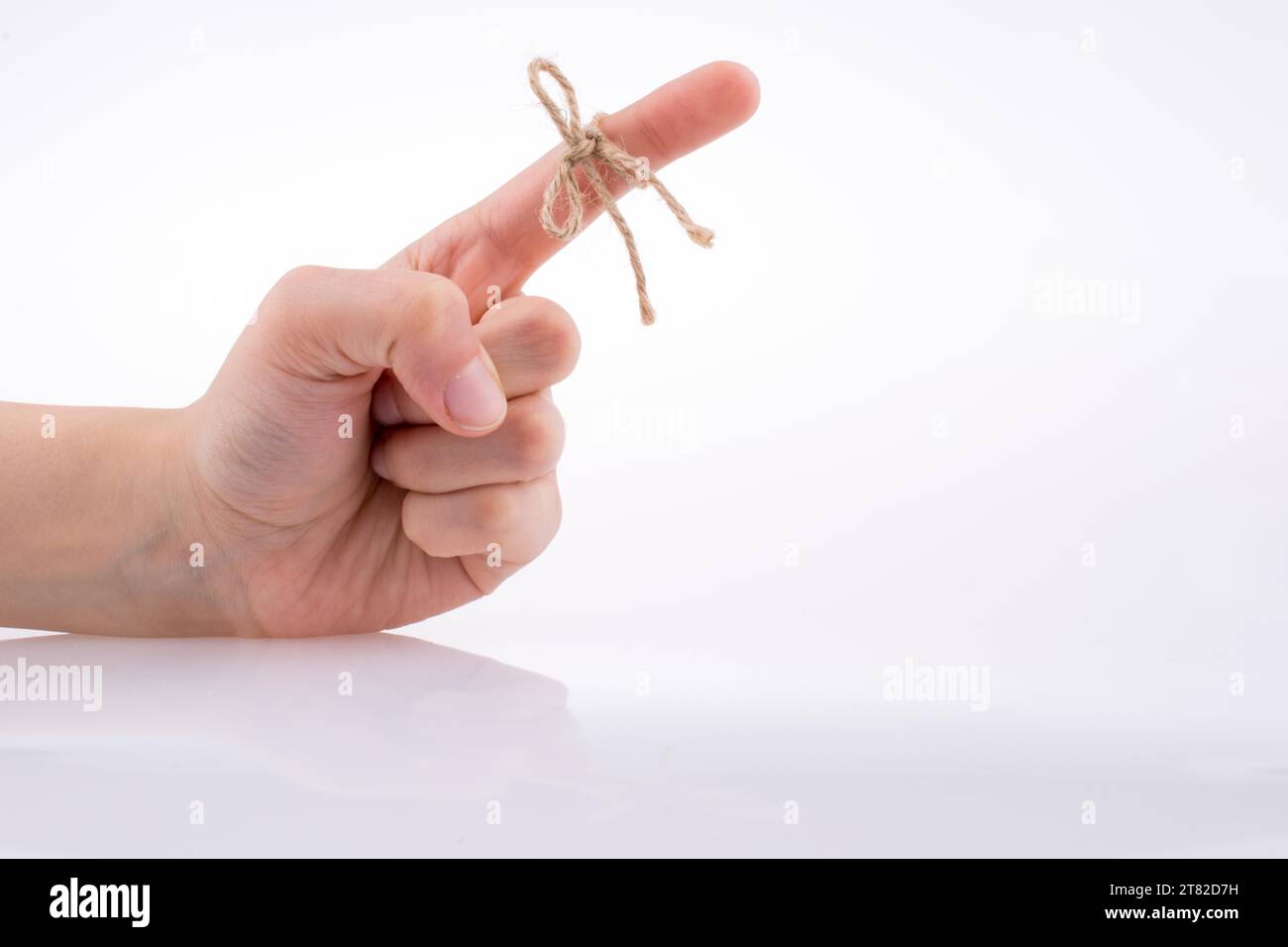 Hand tied with a thread like a ribbon on a white background Stock Photo ...
