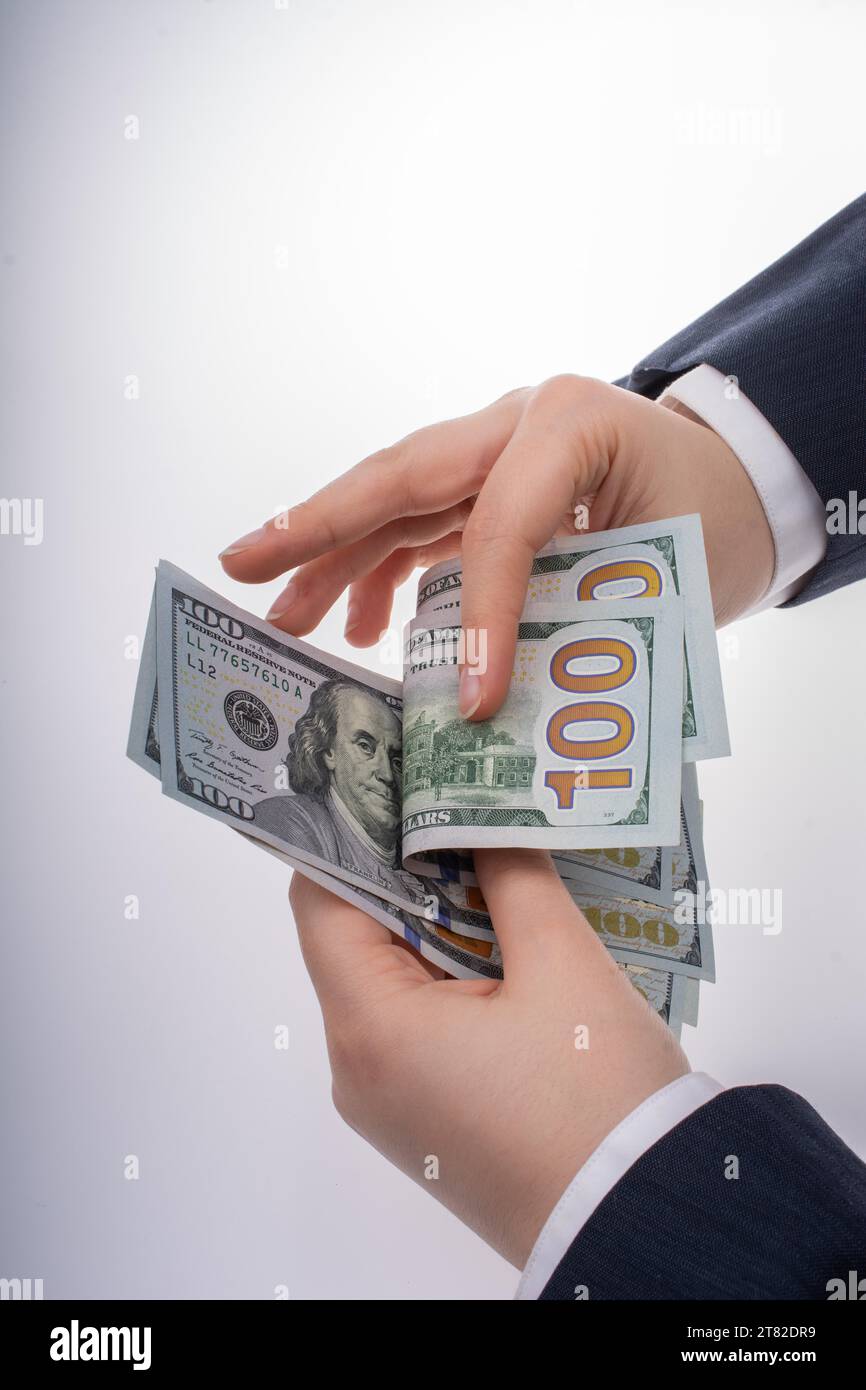 Businessman holding US dollar banknote money on white background Stock ...