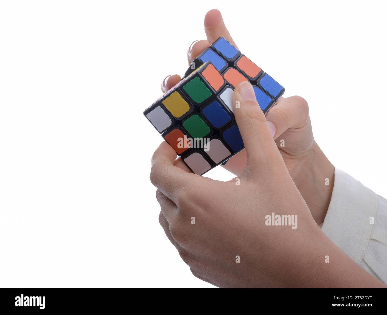 Child holding a Rubik's cube in hand on a white background Stock Photo - Alamy