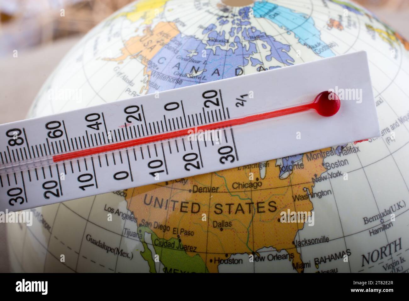 Thermometer placed on a little model globe Stock Photo - Alamy