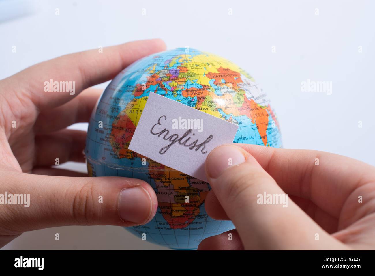 Hand holding notepaper with English wording on model globe Stock Photo ...