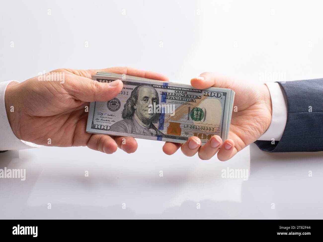 Businessman giving and receiving US dollar banknote money Stock Photo ...
