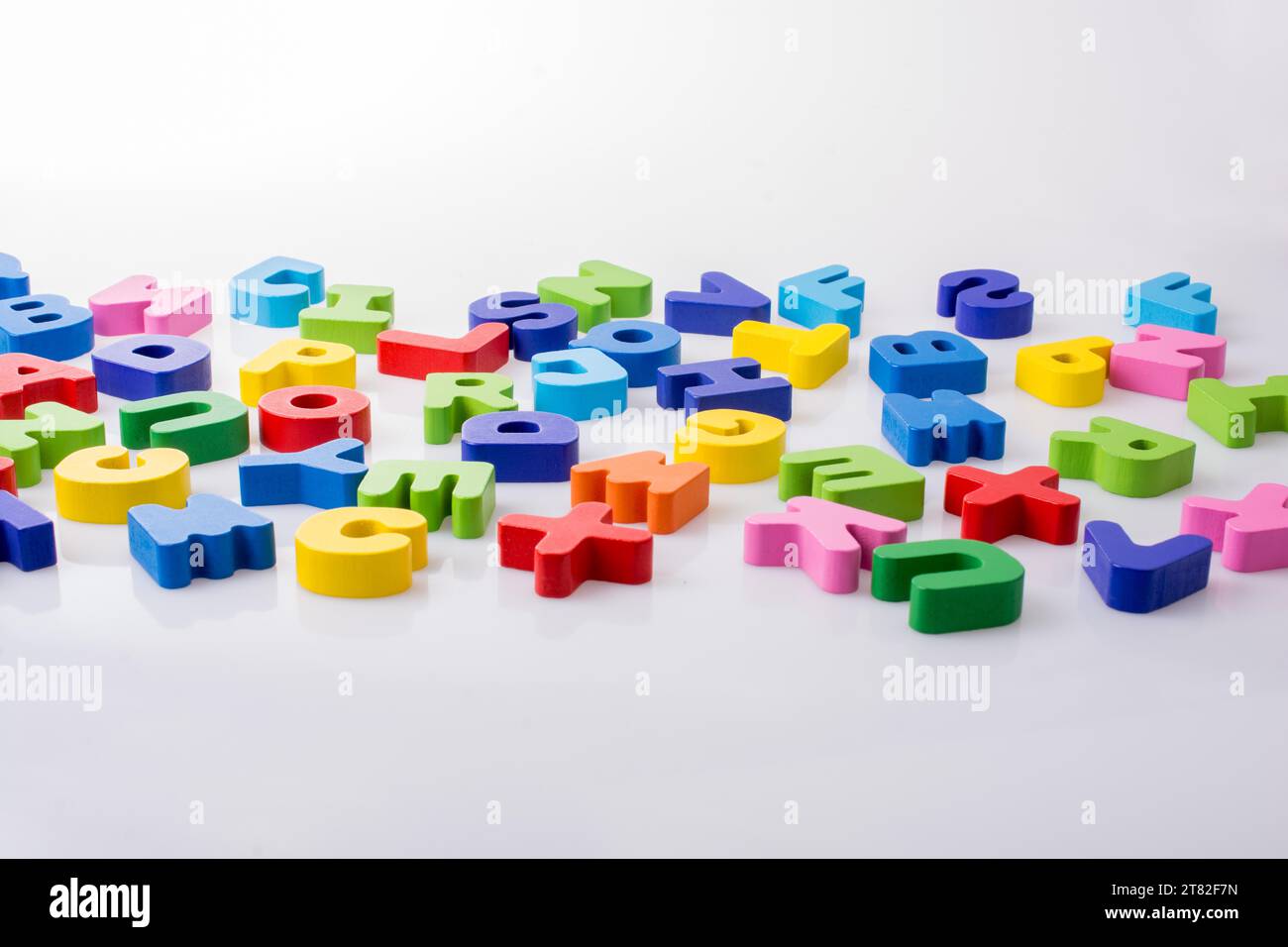 Colorful alphabet letter blocks scattered randomly on white background ...