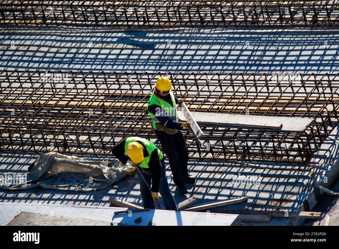 Workers by the side of Iron bars reinforcement concrete bars with wire ...