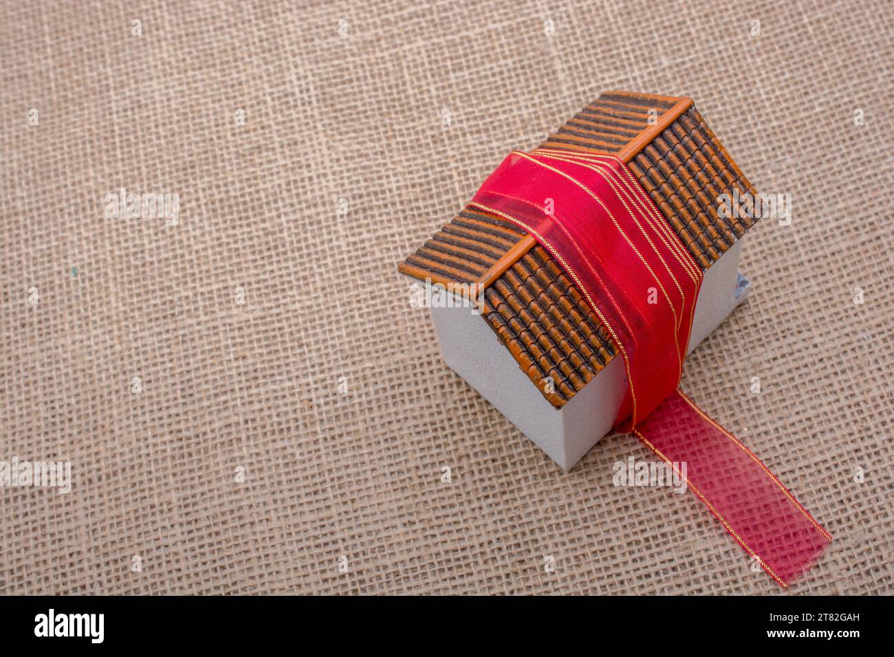Pink band wrapped around a model house on a brown background Stock ...