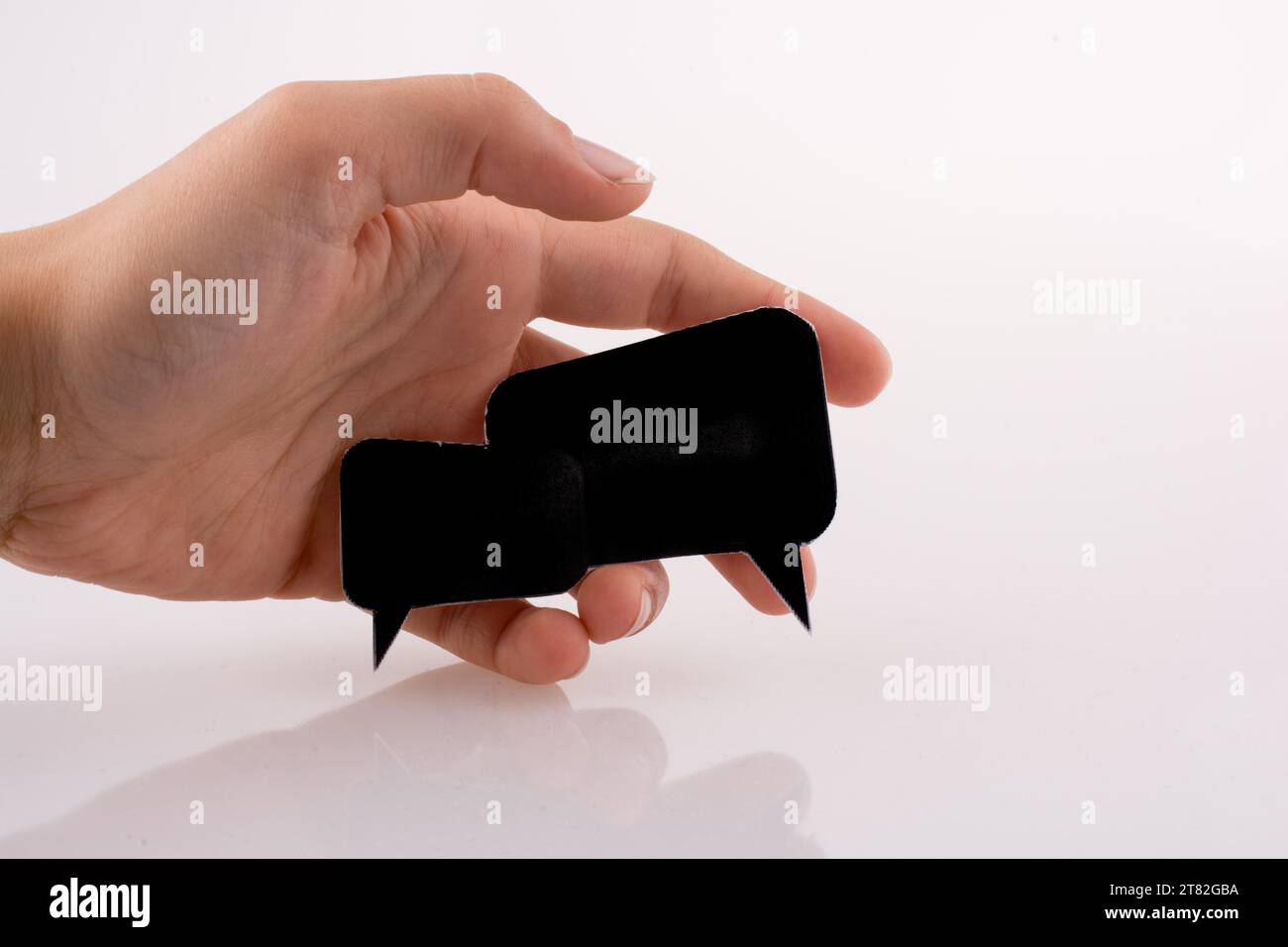 Hand holding dialogue boxes on a white background Stock Photo - Alamy