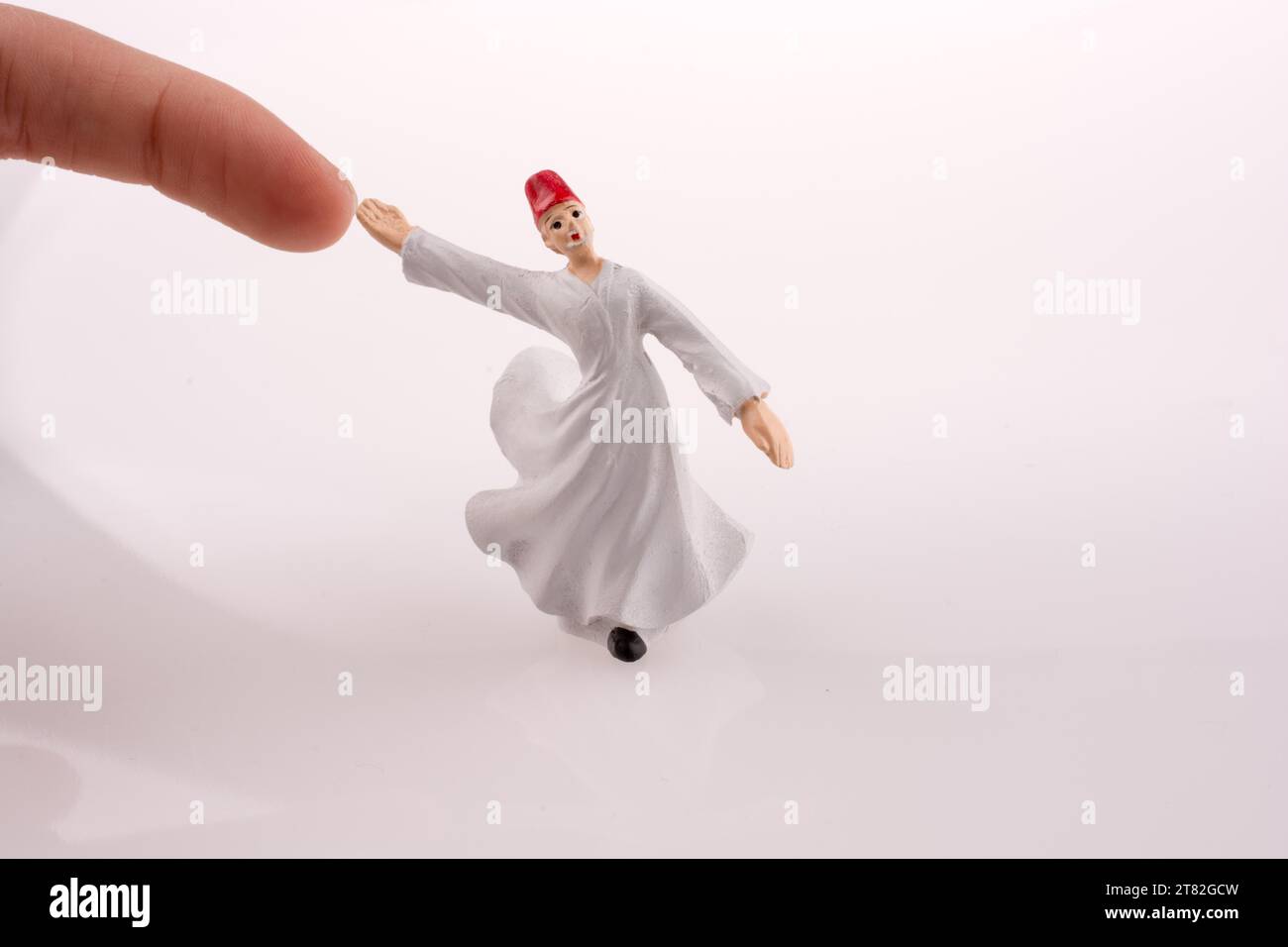 Hand holding a Sufi Dervis on a white background Stock Photo - Alamy