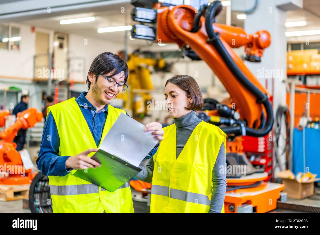 Male and female multi-ethnic engineers reading data while working in a ...