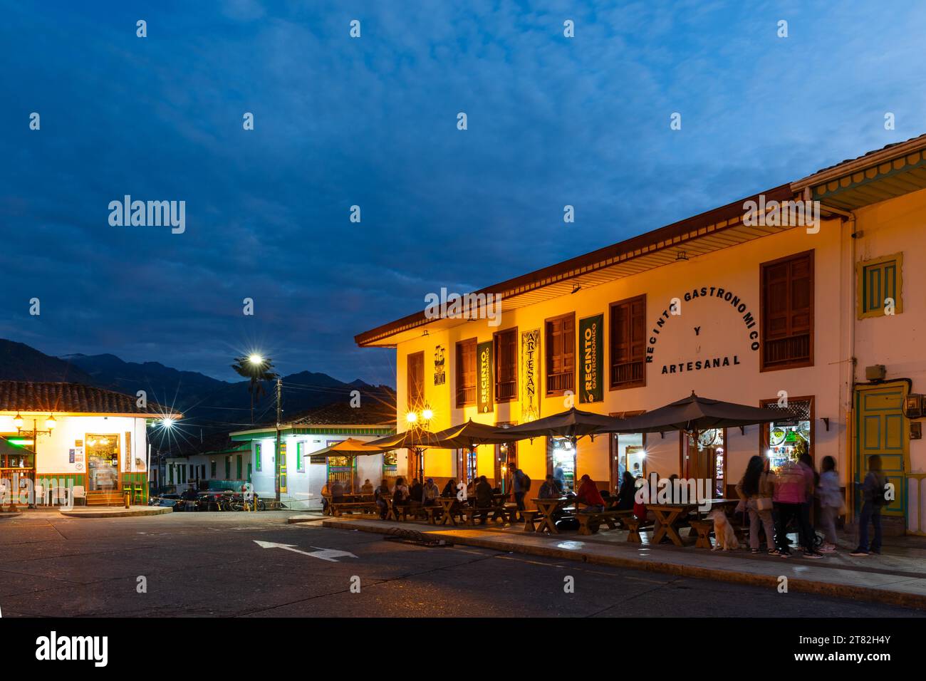 Historic Paisa style houses, outdoor seating of a restaurant, blue hour ...