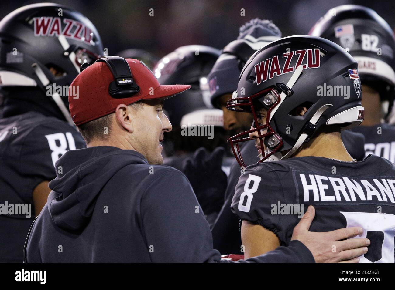 Washington State coach Jake Dickert, left, speaks with wide receiver ...