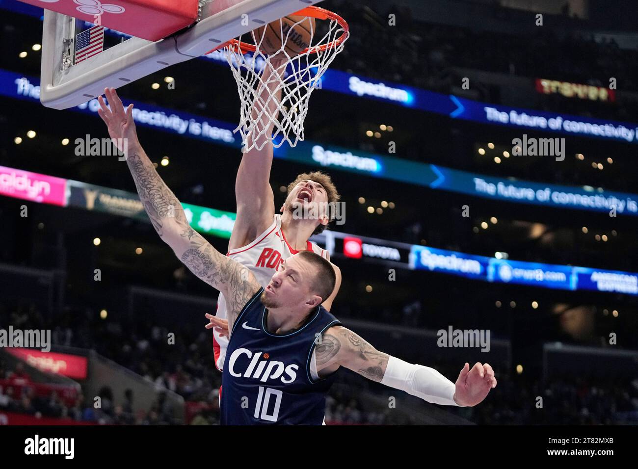 Houston Rockets center Alperen Sengun, top, dunks as Los Angeles ...