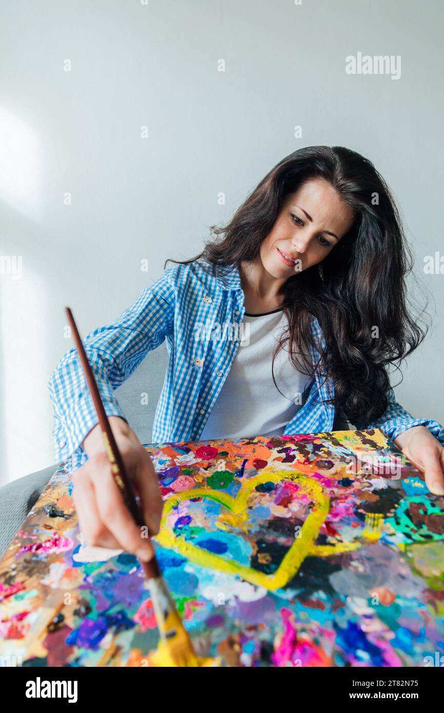 Woman artist painting with paints beautiful picture Stock Photo - Alamy