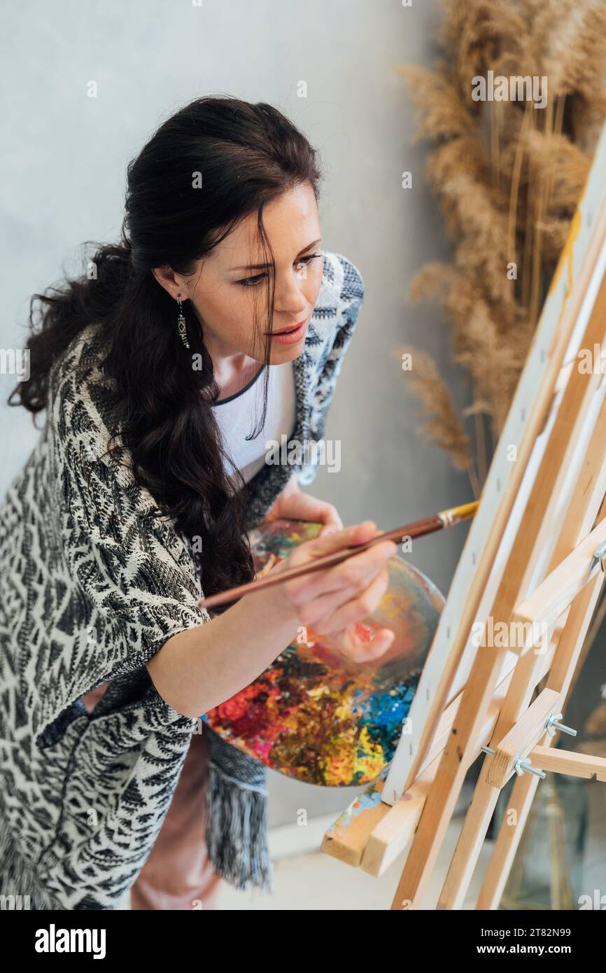 Woman artist painting with paints beautiful picture Stock Photo - Alamy