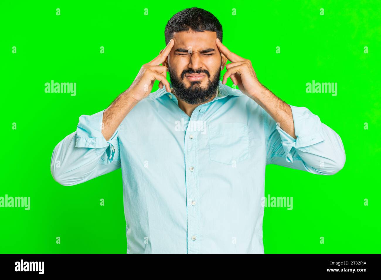 Displeased exhausted Indian man guy rubbing temples to cure headache ...