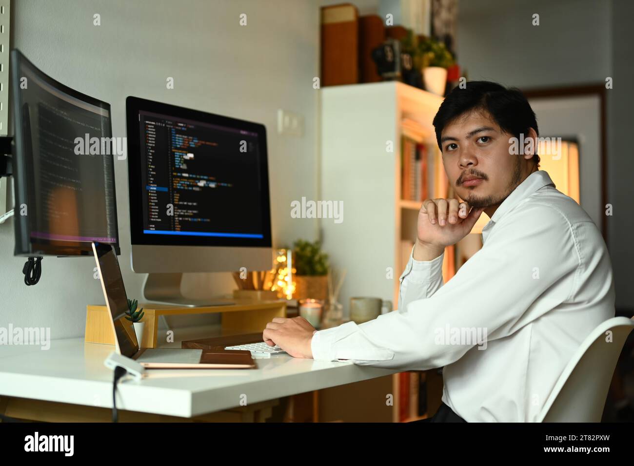 Young professionals web developer writing code on computer monitor at ...