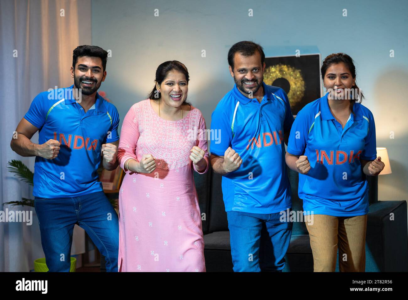 Excited Indian family shouting by celebrating win while watching live ...